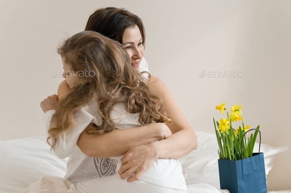 Mothers Day. Morning, mom and child in bed, mother hugging her little daughter Stock Photo by ...