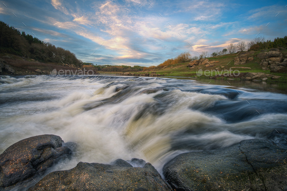 Waterfall over a dam in the Minho river at sunset Stock Photo by ...
