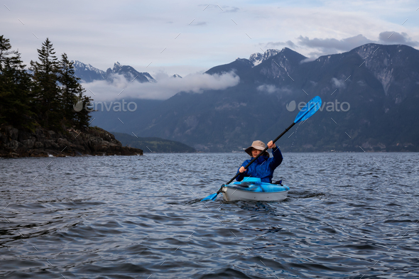 Adventurous man on a kayak is paddling in Howe Sound Stock Photo by edb3_16