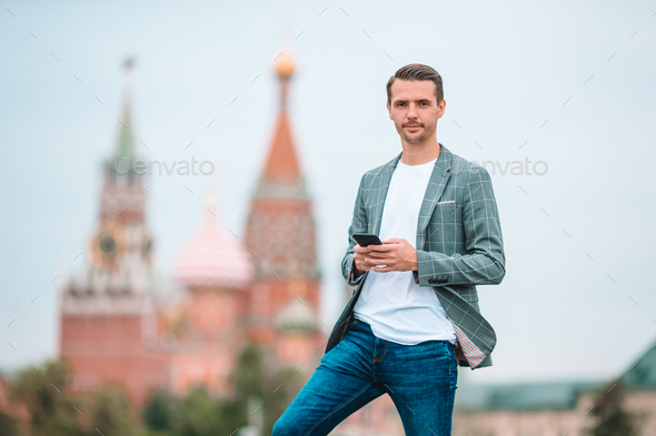 Happy young urban man in european city Stock Photo by travnikovstudio