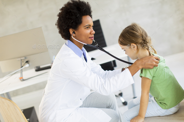 Cute little girl at the pediatrician examination Stock Photo by BGStock72
