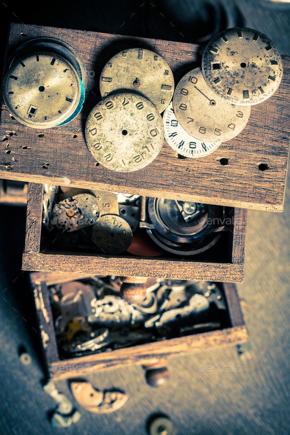 Aged watchmaker's workshop with damaged clocks Stock Photo by Shaiith