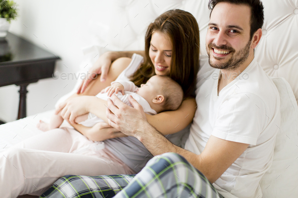 Happy family with newborn baby Stock Photo by BGStock72 | PhotoDune