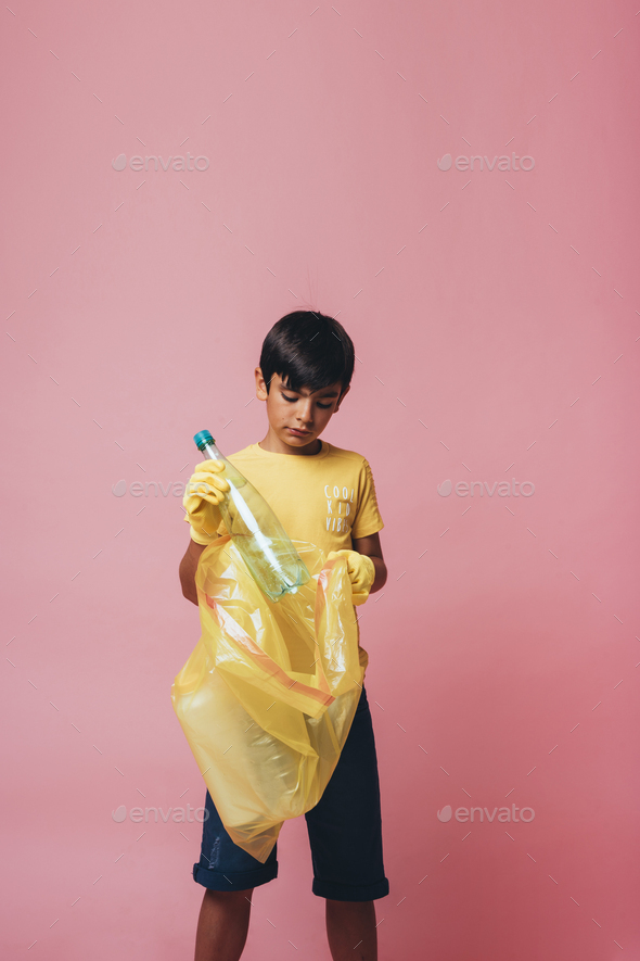 Little boy who recycles plastic bottles in the yellow bag Stock Photo ...