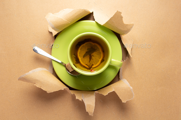 Cup of tea with lemon and honey on torn paper. Mug full green tea Stock ...
