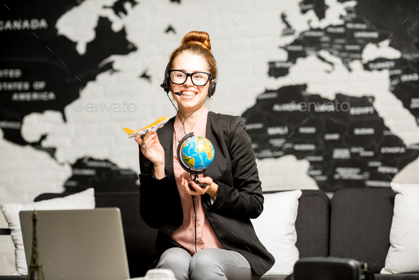 Travel agent portrait on the world map background Stock Photo by RossHelen