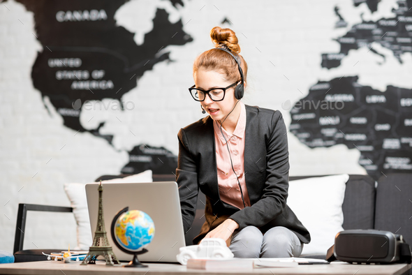 Travel agent portrait on the world map background Stock Photo by RossHelen