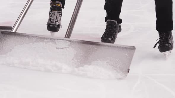 Workers Clean Ice with Shovels Skating Along Rink at Hockey, Stock Footage