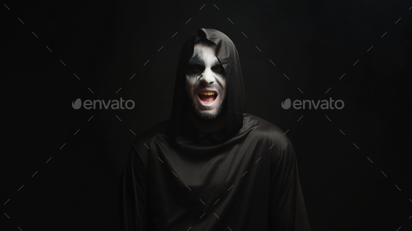 Grim reaper with scary laughing over black background Stock Photo by DC ...