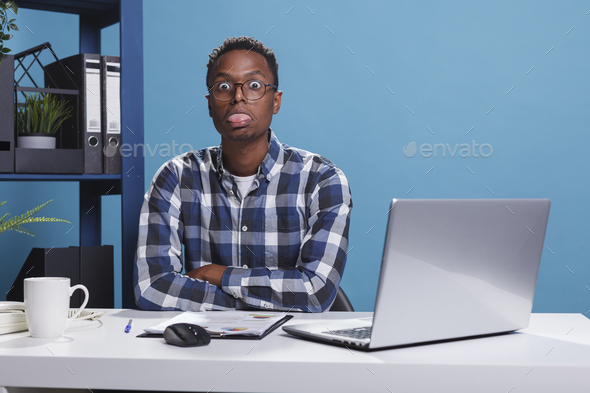 Funny and goofy office working person making amusing playful face while ...