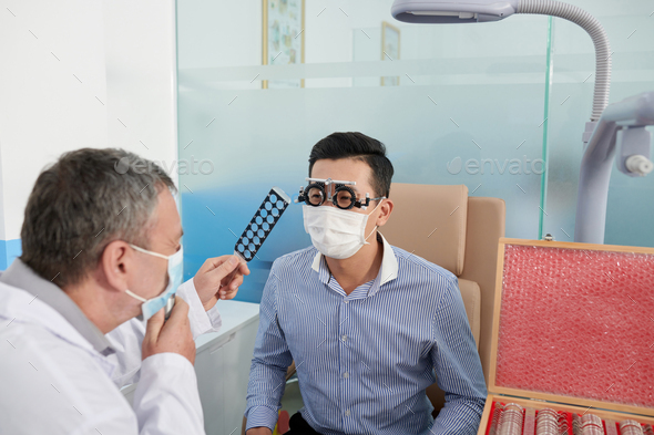 Ophthalmologist Using Retinoscopy Racks Stock Photo by DragonImages