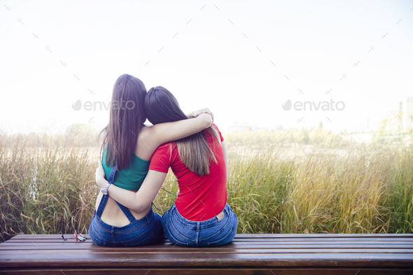 Two best female friends embracing together Stock Photo by BGStock72