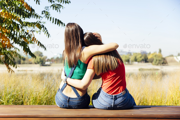 Two best female friends embracing together Stock Photo by BGStock72