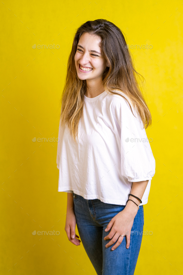 Studio photography of girl smiling on yellow background. Stock Photo by ...