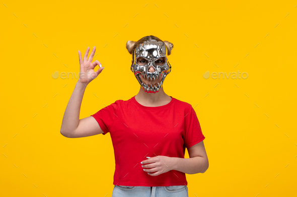 beautiful young woman with scary golden mask yellow background girl ...