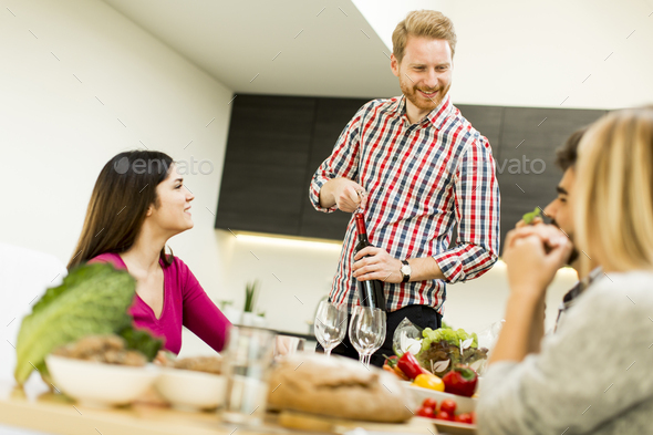 Young people have a meal in the dining room in modern home Stock Photo ...
