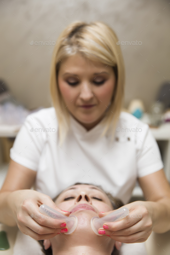 Cup applied to facial skin of a female patient as part of the ...