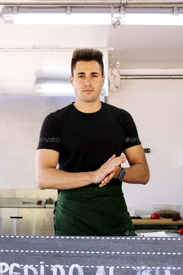 Food truck concept. Waiter waiting for customers. Stock Photo by armacuatro
