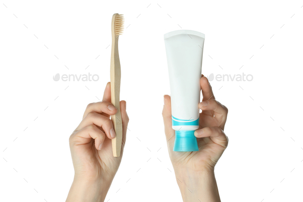 Female hands hold toothpaste and toothbrush, isolated on white ...