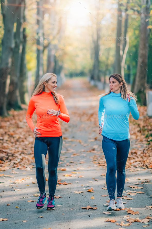 Women Running in Public Park in the Fall. Stock Photo by microgen ...