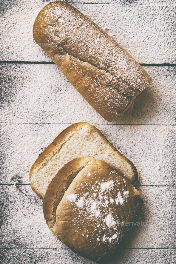 Bakery concept. Sliced bread and loaf of bread Stock Photo by armacuatro