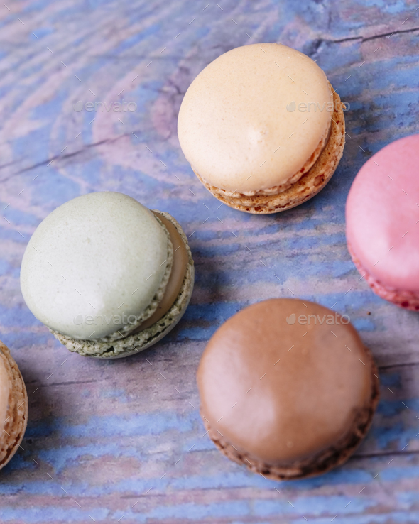 Stacked macarons of different flavors on an old wooden table. Stock ...