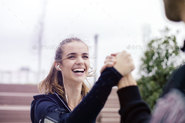 Young woman is shaking the arm of her personal trainer Stock Photo by ...