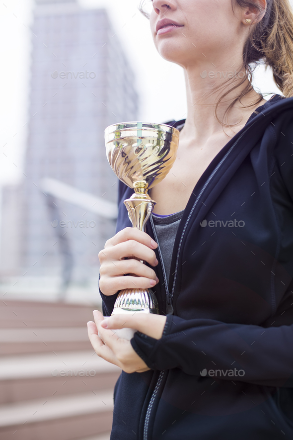 Sport woman holding a trophy Stock Photo by BGStock72 | PhotoDune