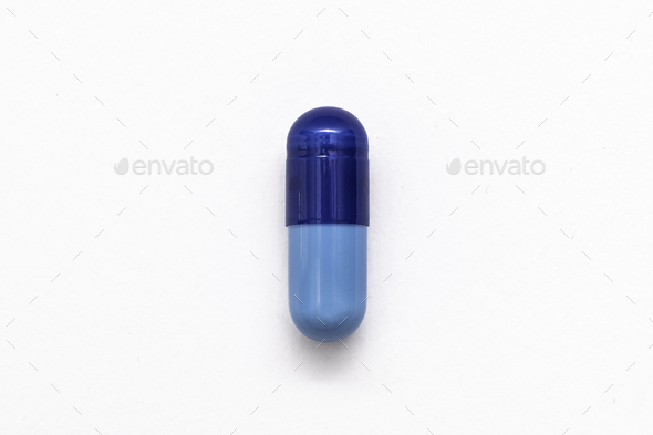 Close-up one blue powder soft capsule pill isolated on white. medicine ...