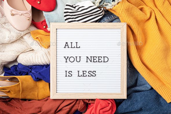 Fast fashion background with pile of cheap, low quality clothes ...