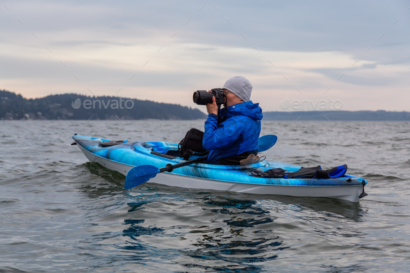Adventurous man on a kayak is paddling in Howe Sound Stock Photo by edb3_16
