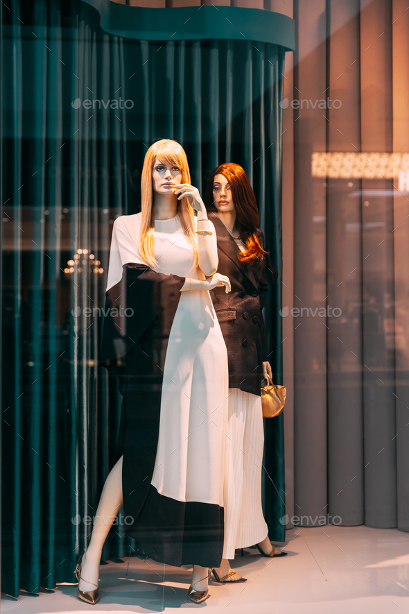 Female mannequin in shop window showcase of store mall market. Fashion ...