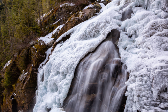 View of a waterfall, Crooked Falls, covered in melting ice during ...