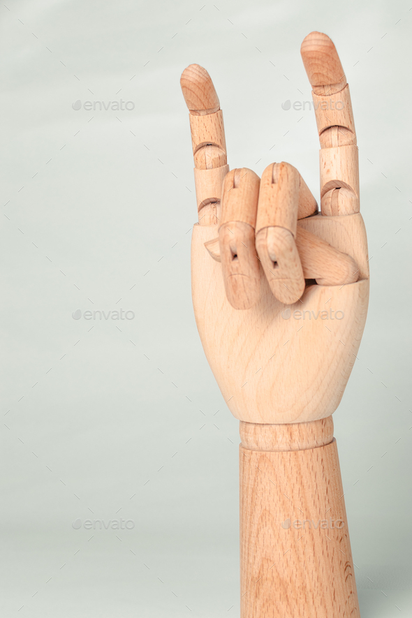 Wooden hand raised with the heavy metal symbol. Stock Photo by armacuatro