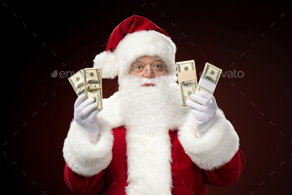 Santa Claus showing dollars Stock Photo by LightFieldStudios | PhotoDune