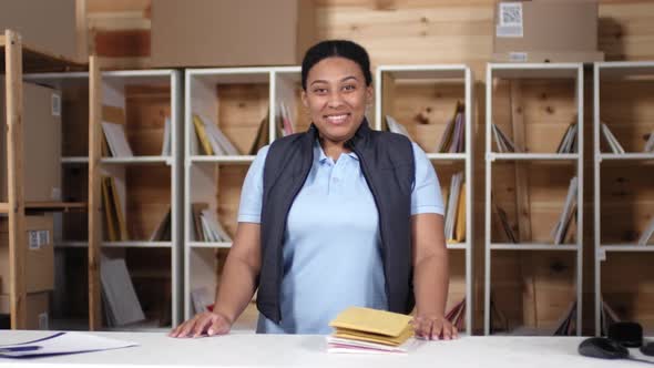 Happy Female Postal Service Clerk Smiling behind Counter, Stock Footage