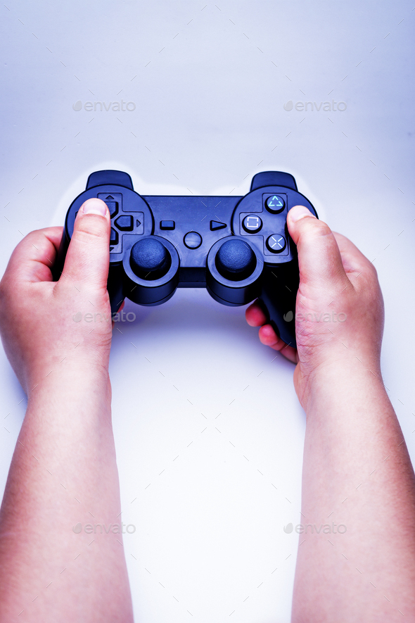 Child hands playing with the black remote of a console. Stock Photo by ...
