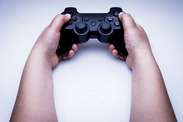 Child hands playing with the black remote of a console. Stock Photo by ...