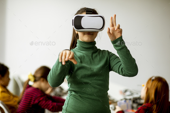 Cute little girl wearing VR virtual reality glasses Stock Photo by ...