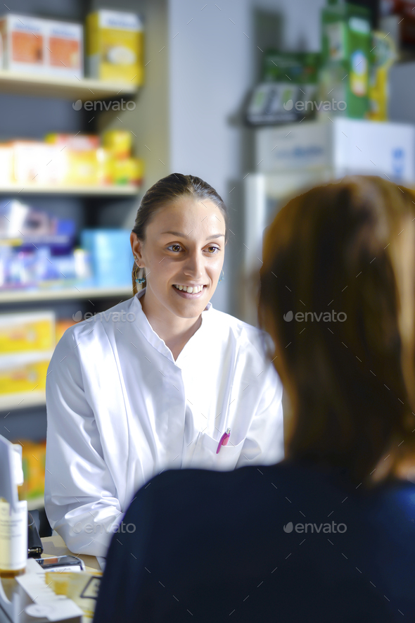 pharmacist staff counseling customer about drugs usage in modern ...