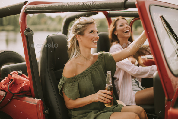 Attractive young women in a convertible car Stock Photo by BGStock72