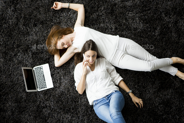 Young women laying on the carpet Stock Photo by BGStock72 | PhotoDune