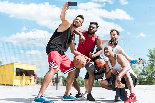 multicultural team of basketball players taking selfie together Stock ...