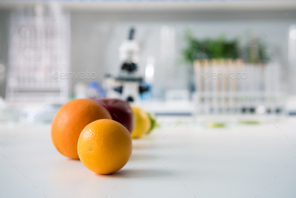 Scientific tools and fruits at workplace in modern biological ...