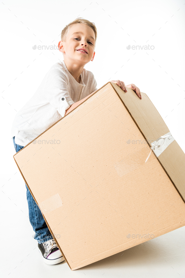 Cute smiling little boy standing with cardboard box isolated on white ...