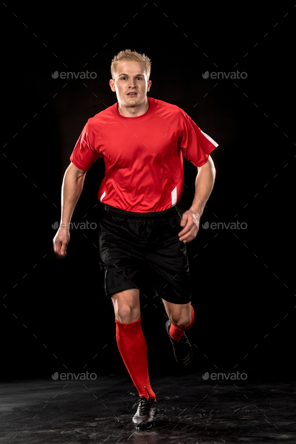 Soccer player in red and black uniform running Stock Photo by ...