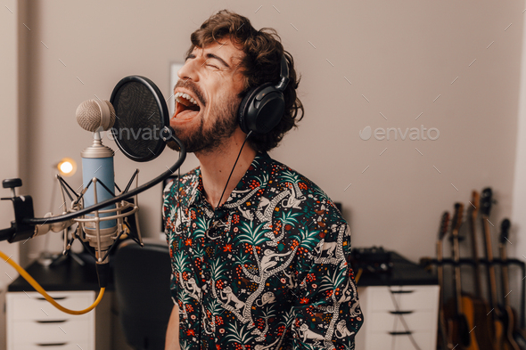 Young singer laying down tracks in a recording home studio Stock Photo ...