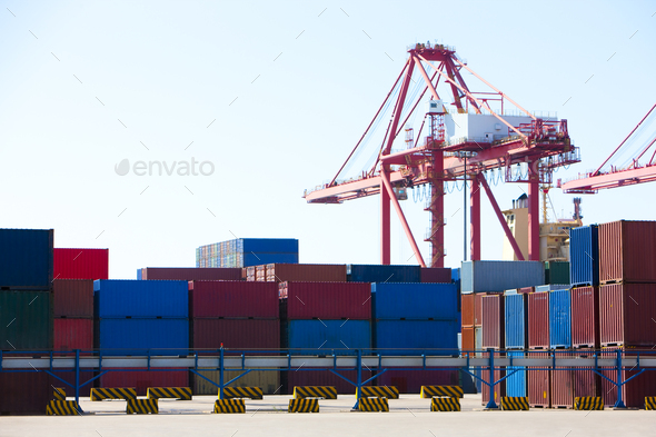 Cranes and cargo containers in shipping dock Stock Photo by bluejeanimages