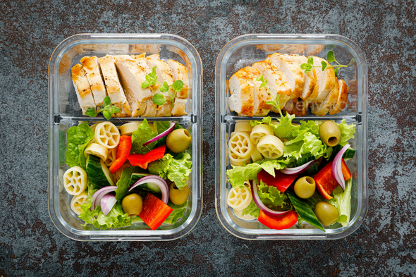 Lunch boxes with grilled chicken breast and pasta salad with fresh ...