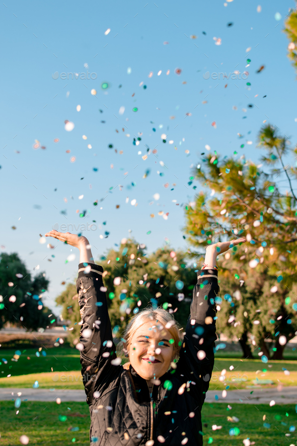 Beautiful happy woman at celebration party with confetti falling ...